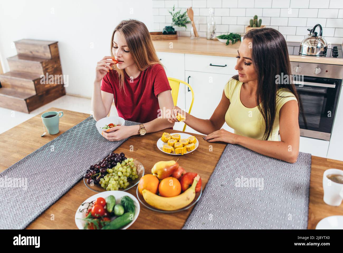 Two young women friends sitting hi-res stock photography and images - Alamy