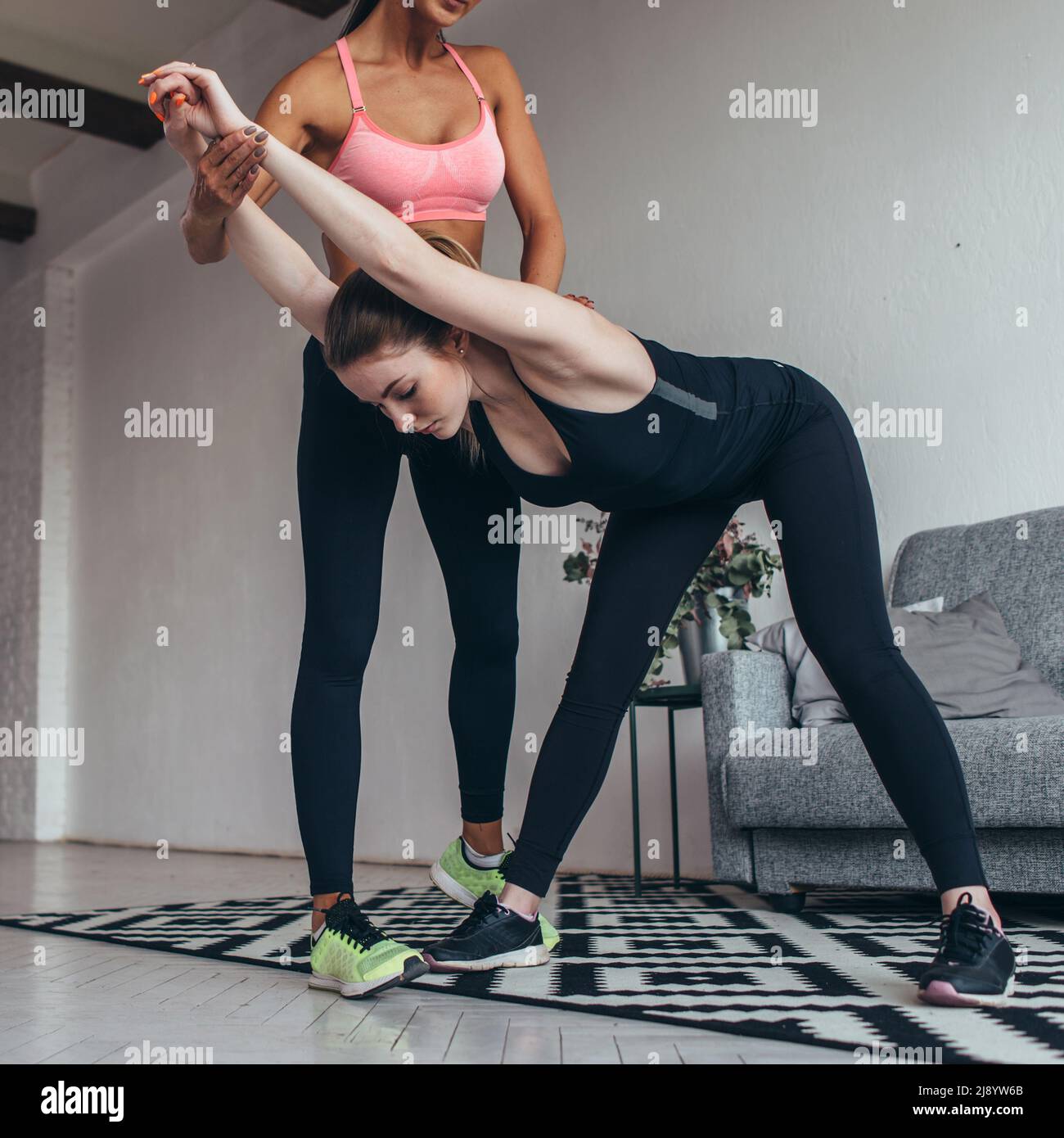 Two fit woman exercising doing stretching back Stock Photo - Alamy
