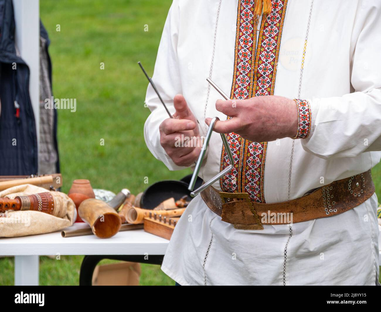 Musician man plying triangle striking with beater. Ukraininan hand ...