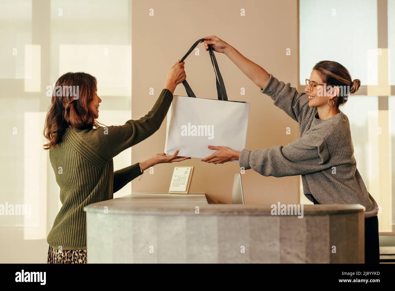 Handing items hi-res stock photography and images - Alamy