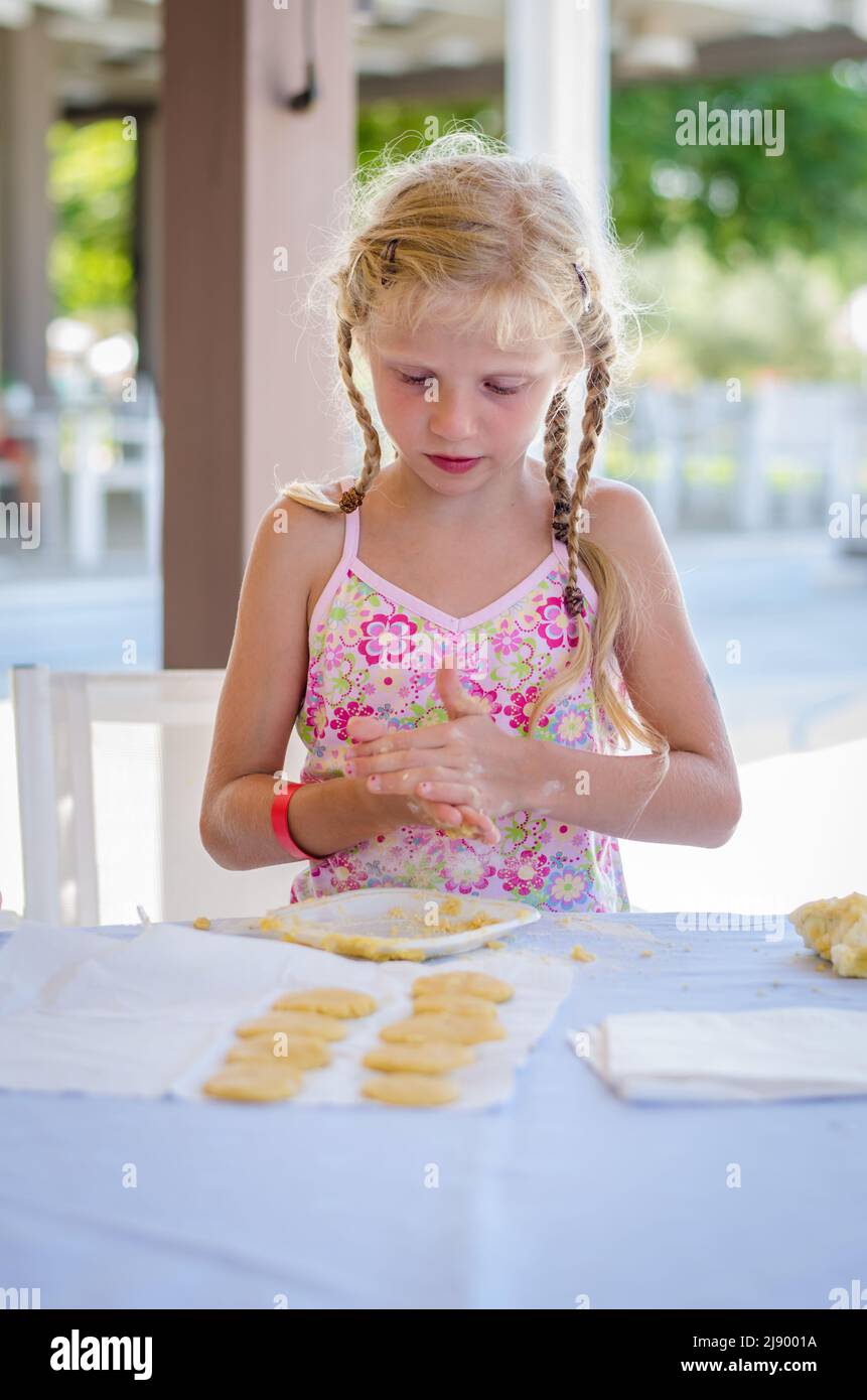 cute little child preparing sweet cakes Stock Photo - Alamy