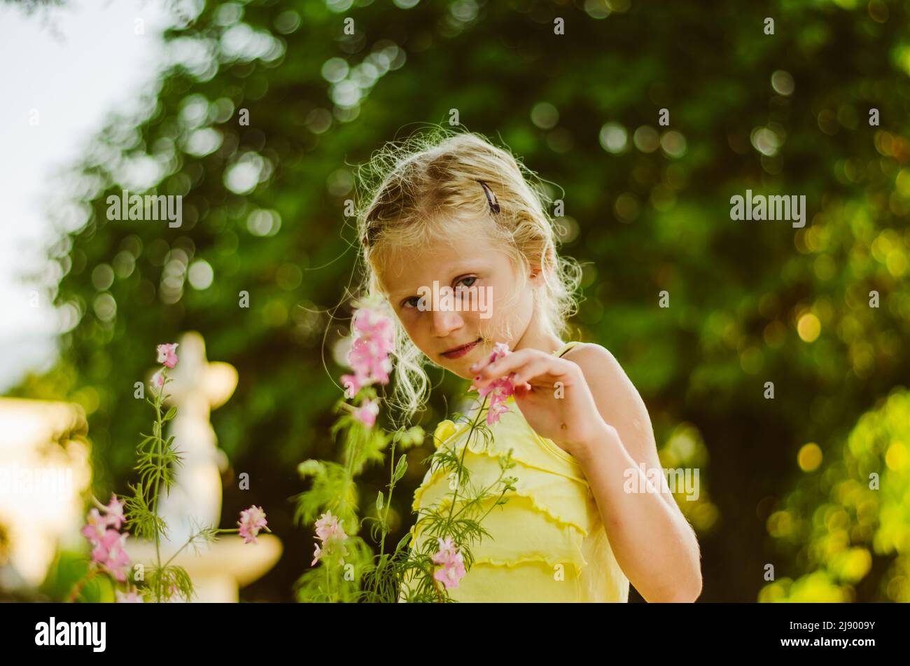 romantic child with pink flowers portrait Stock Photo - Alamy