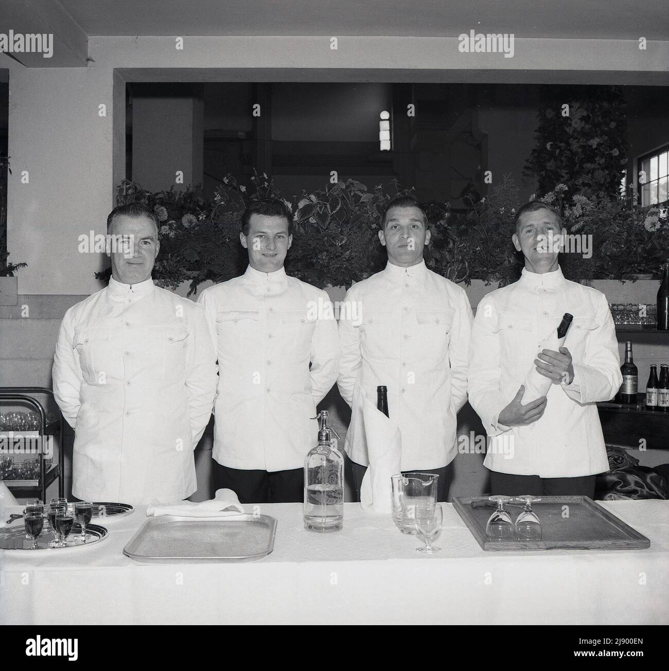 1960s, historical, four male waiters in their uniform standing together ...