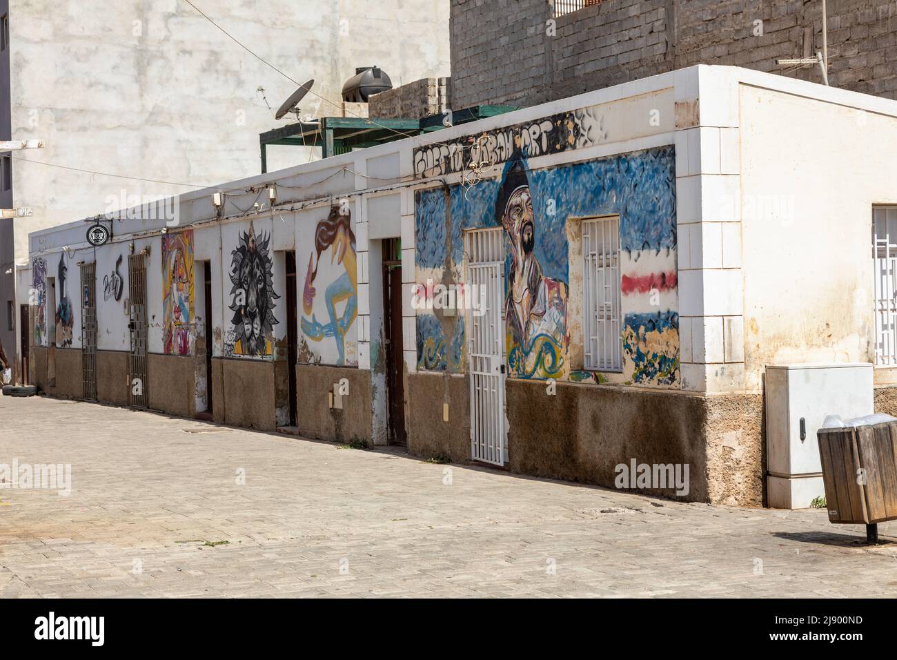 Murals painted on buildings in a street scene in Espargos, Verde Island ...