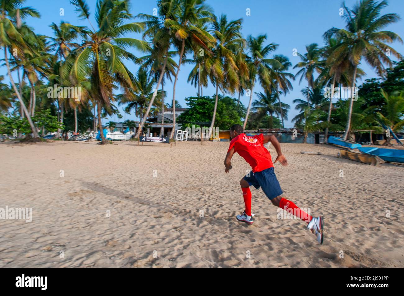 Local training running in the beach of Las Terrenas beach, Samana ...
