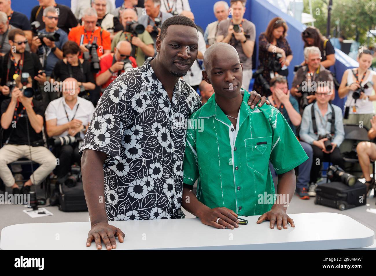Cannes, France. 19th May, 2022. Alassane Diong and Omar Sy attend the ...