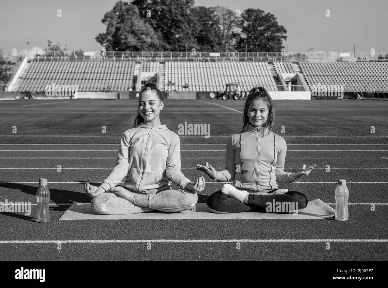 healthy children girls training fitness on stadium running track ...