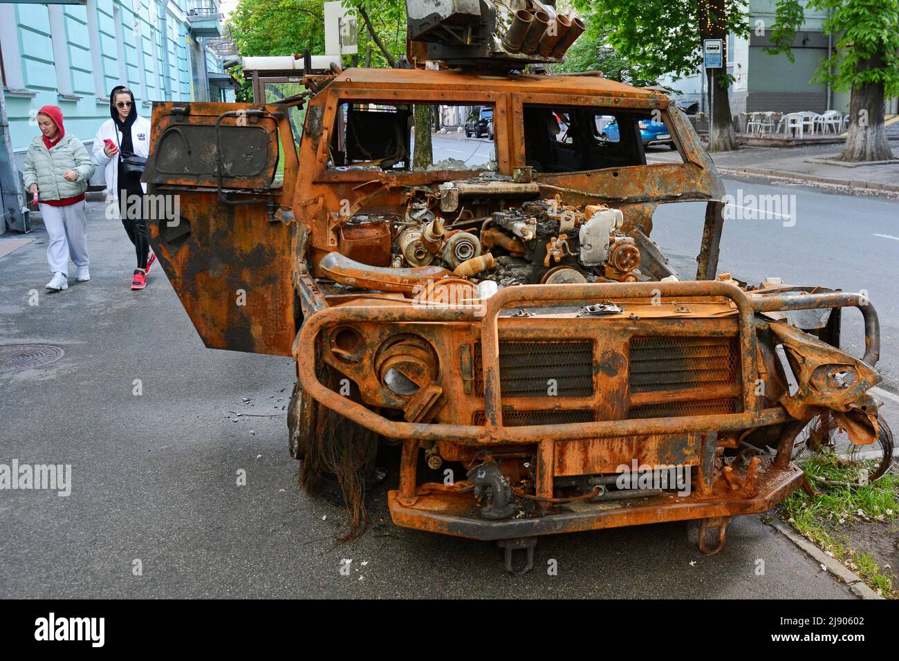 Pedestrians look at the destroyed Russian special armored vehicle "Tigr ...