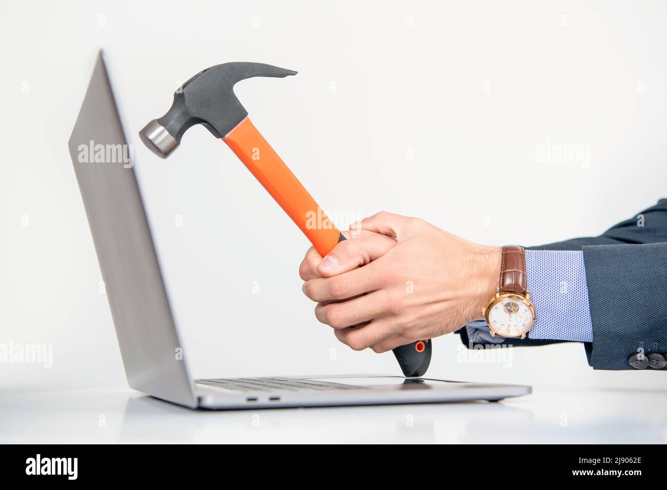 hammer in hand hitting the laptop, closeup Stock Photo - Alamy