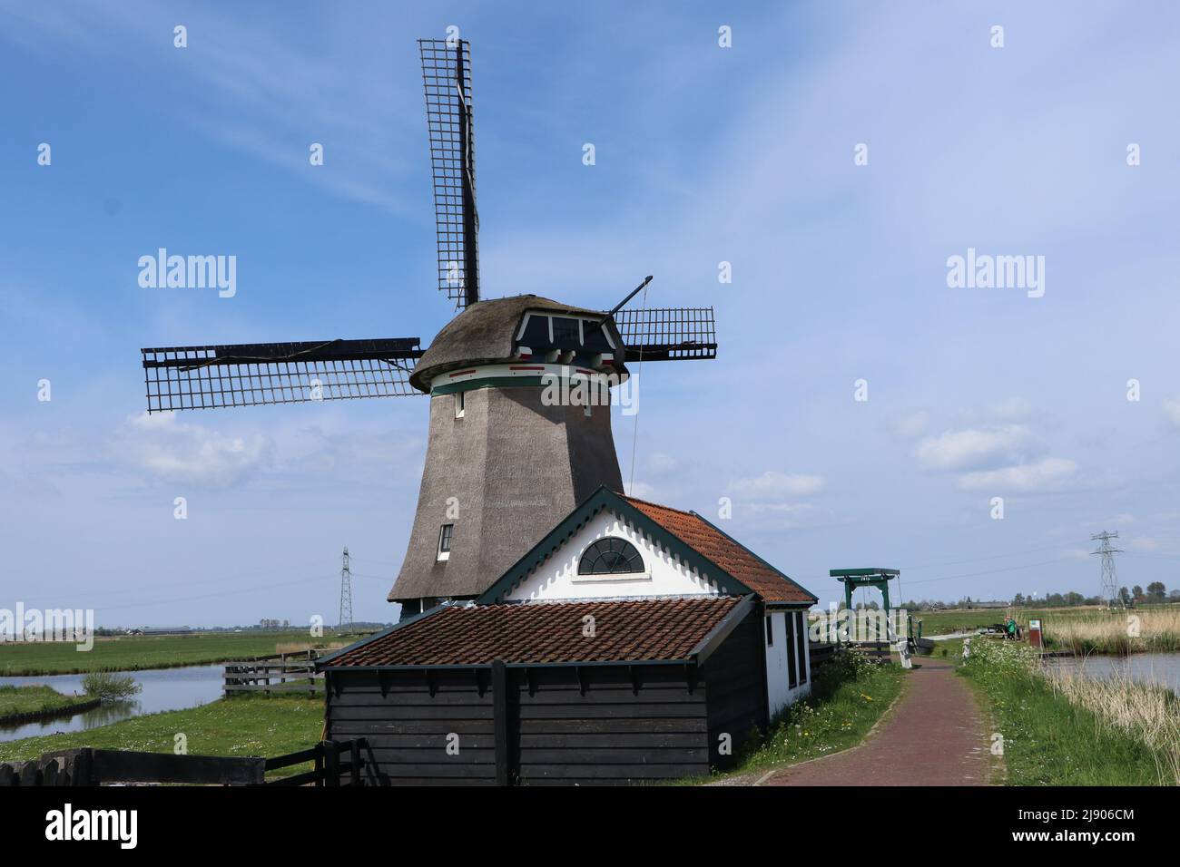 traditional drainage windmill called De Woudaap in countryside in North ...