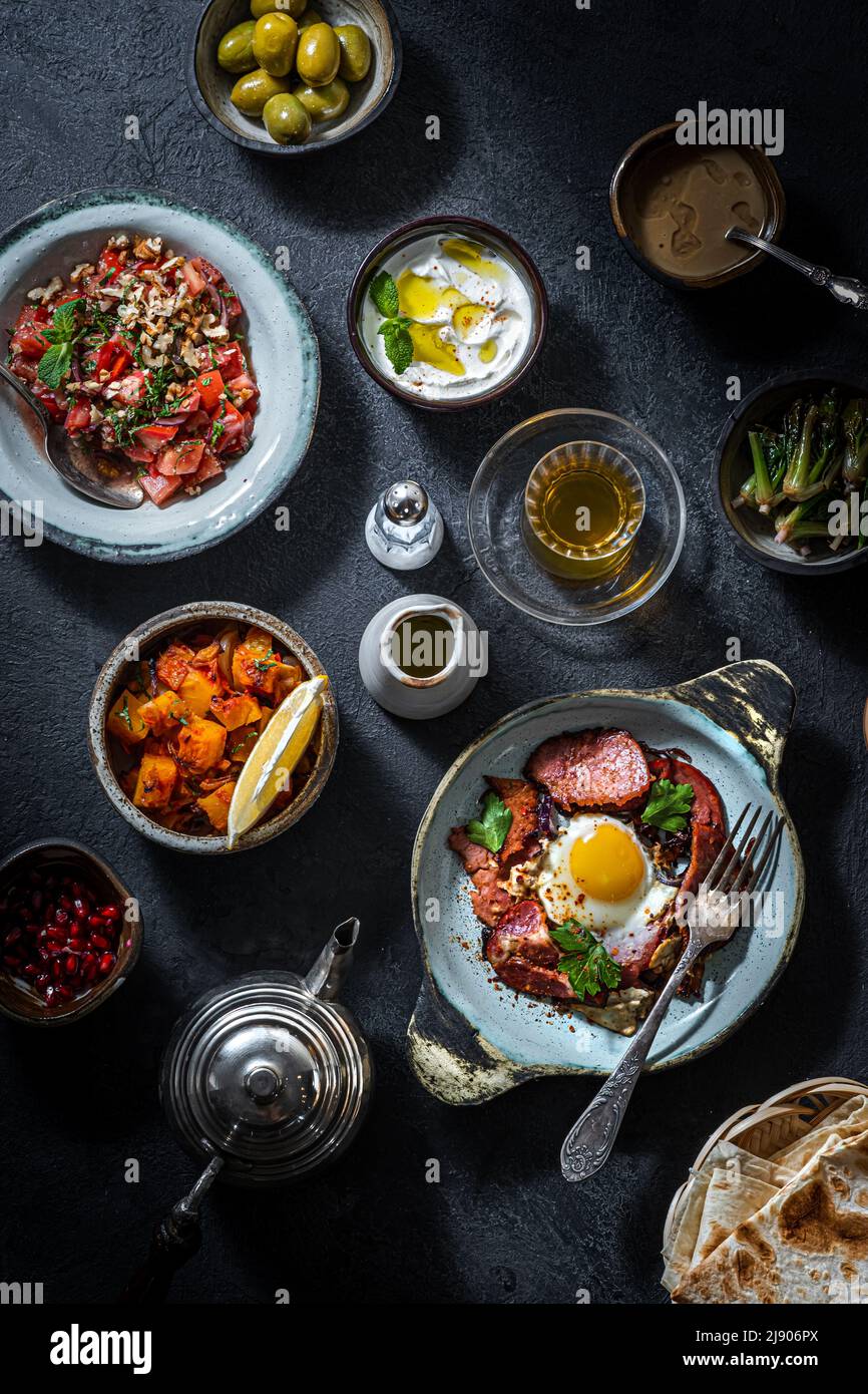 Turkish breakfast table. Flat-lay pastries, vegetables, greens, olives ...