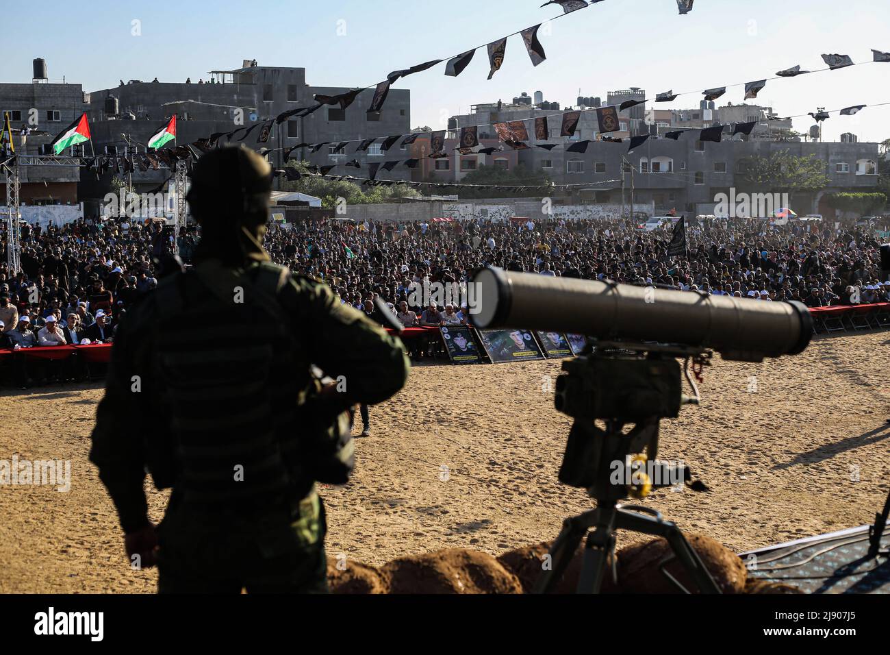 A Palestinian fighter stands near a "cornet cannon" displayed on the ...