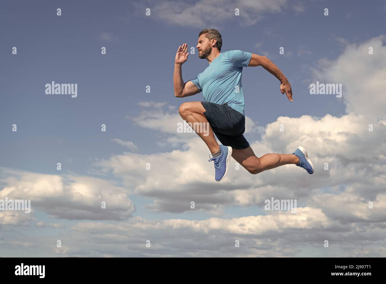 energetic man athlete with muscular body run in sportswear outdoor on ...