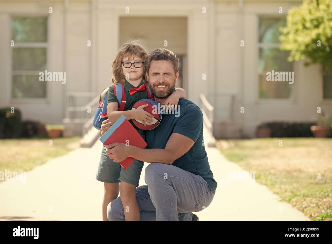 father and son come back from school. happy family values. childhood ...