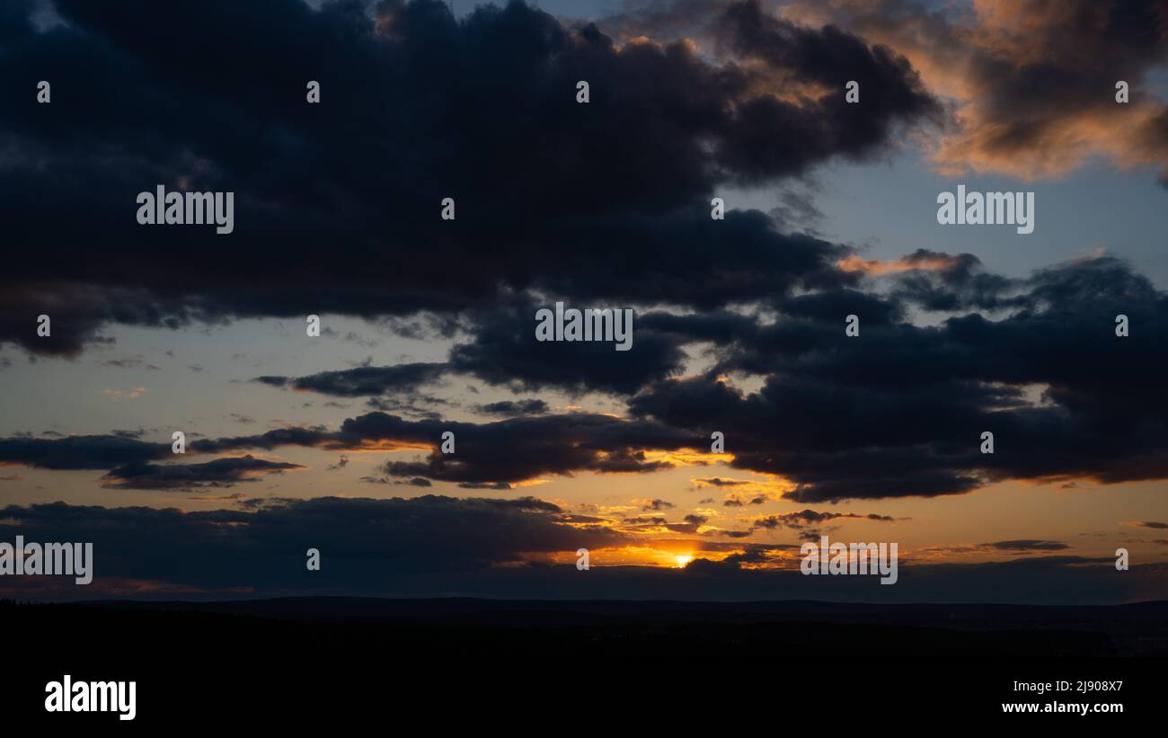 Dramatic sky with clouds and bright sun. Dark sunset in a cloud Stock ...