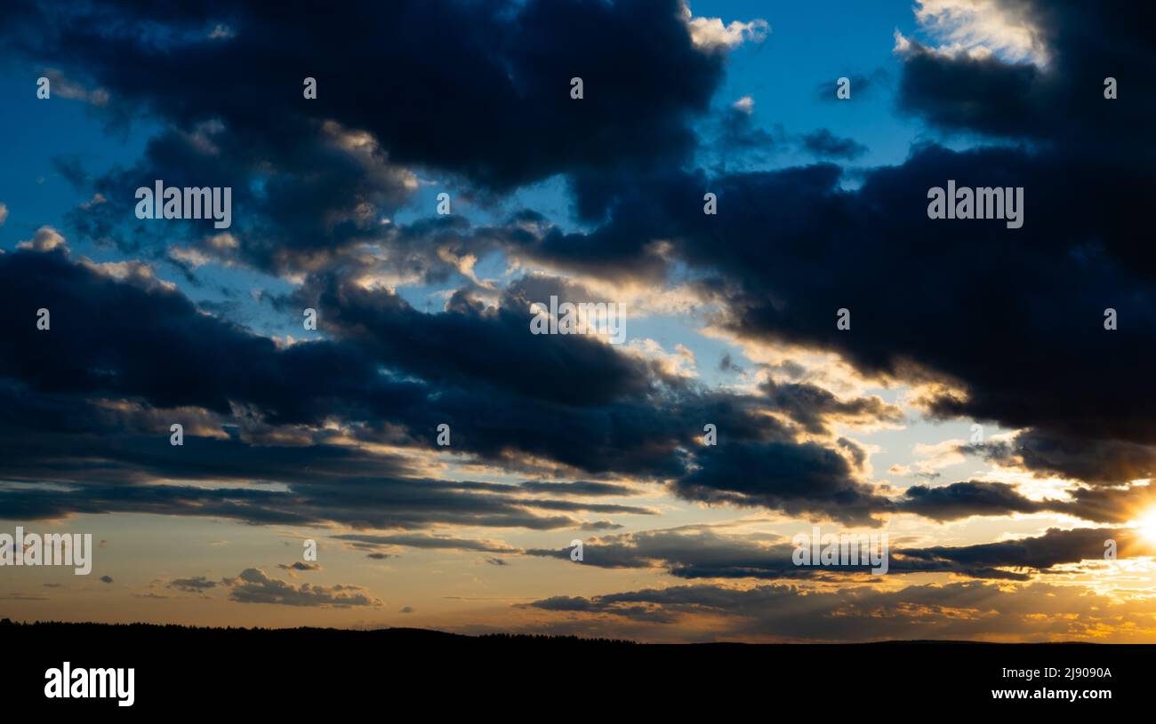 Dramatic sky with clouds and bright sun. Dark sunset in a cloud Stock ...
