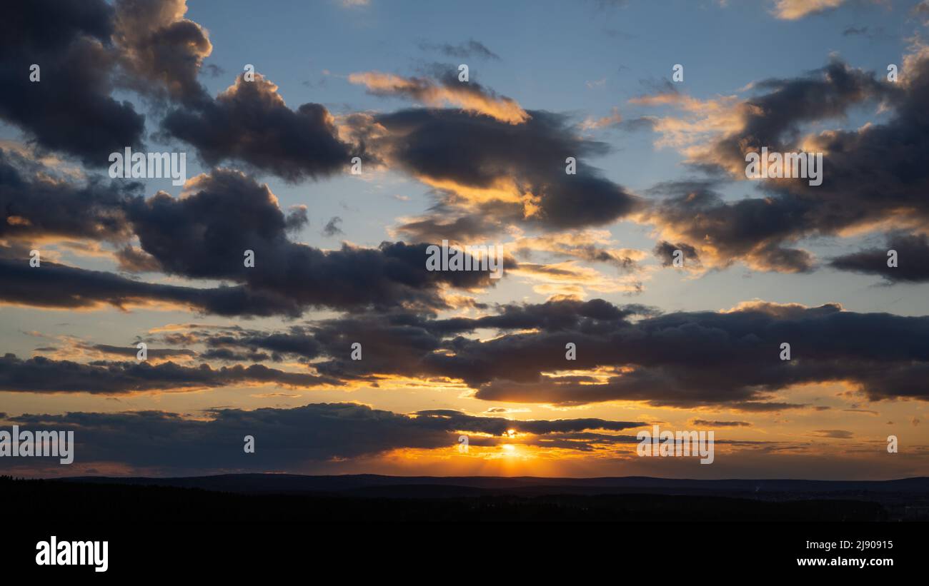 Dramatic sky with clouds and bright sun. Dark sunset in a cloud Stock ...