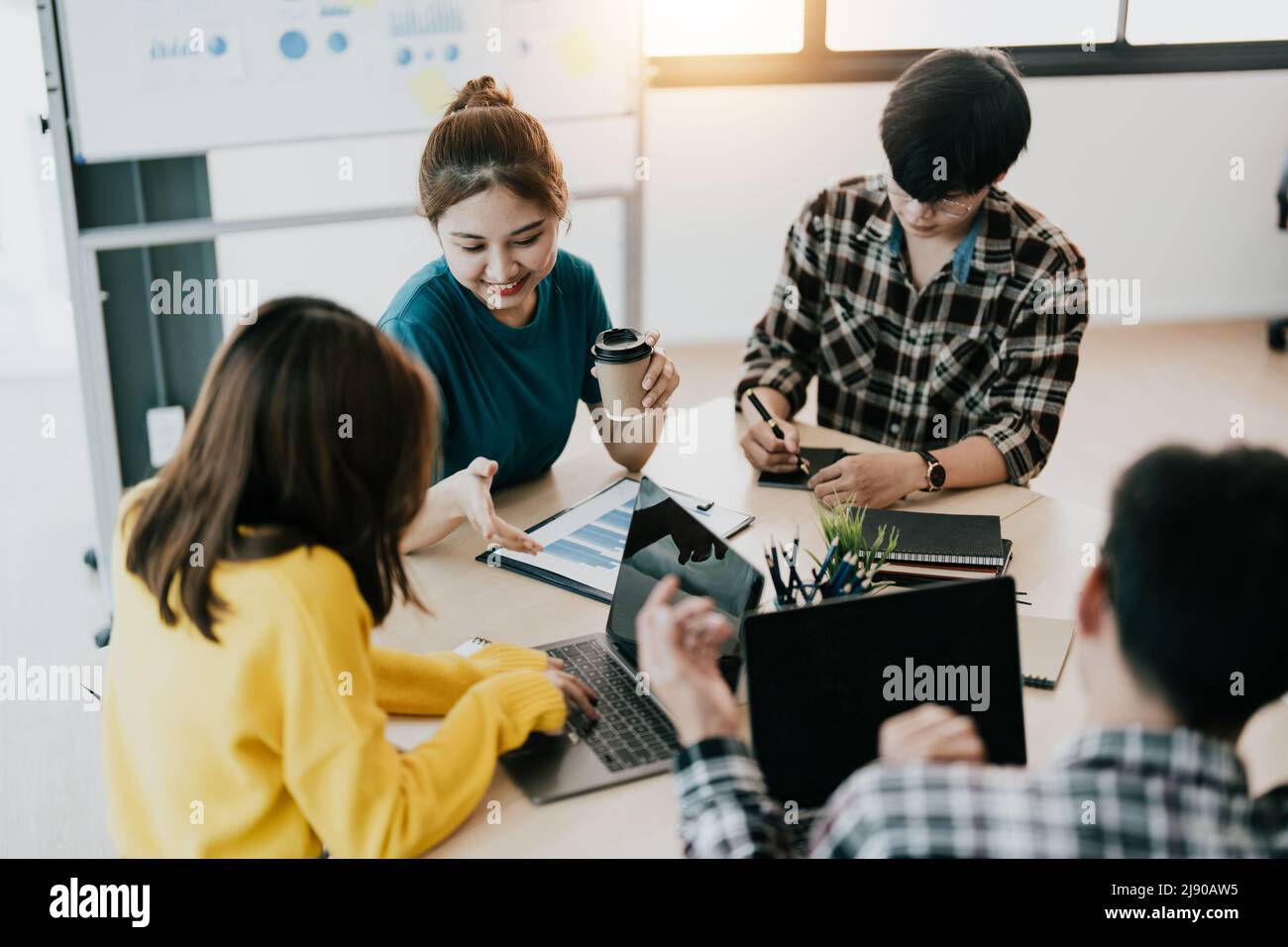 Young people working together in the office. Collaborating with ...