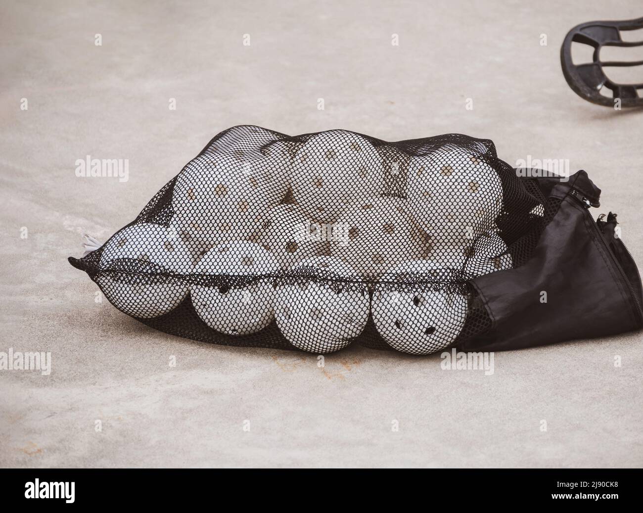 Floorball balls in bag ready for training. Children playing outdoor in ...