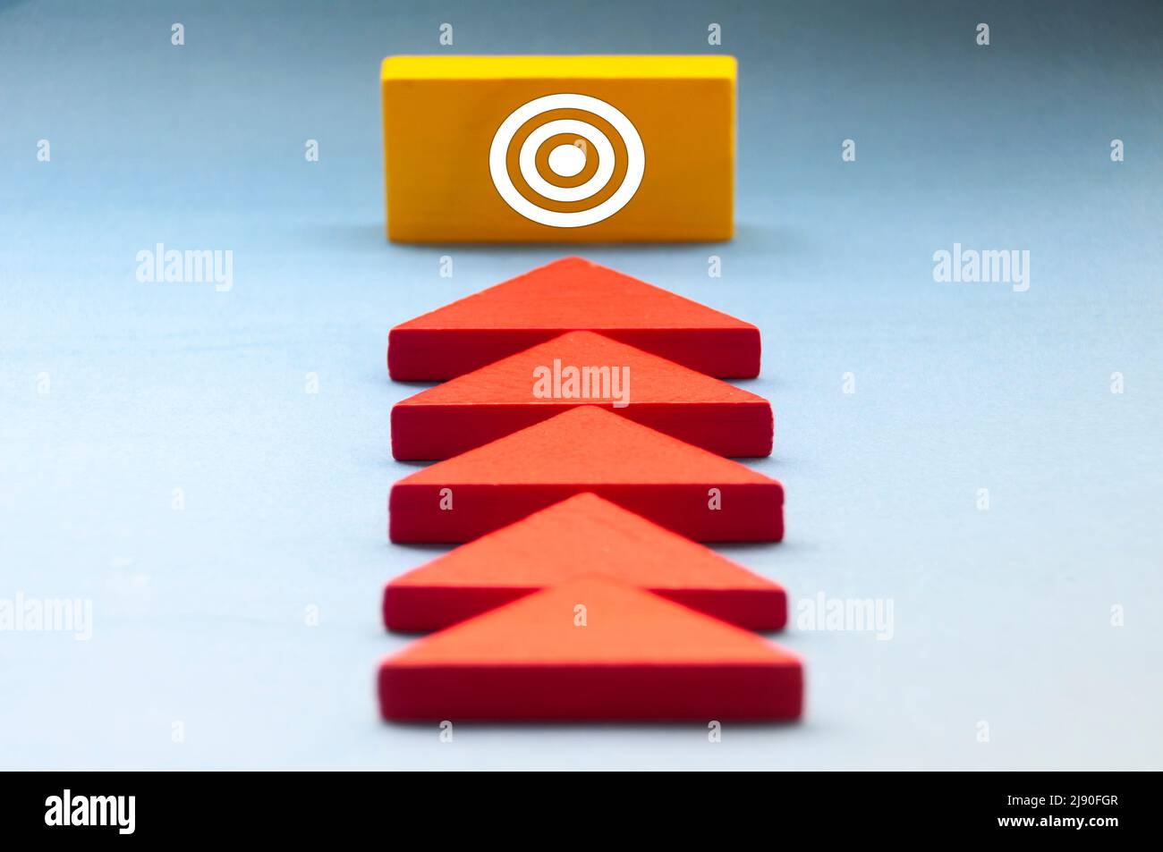 Triangles shape and target symbols on wooden blocks. Goal setting in ...