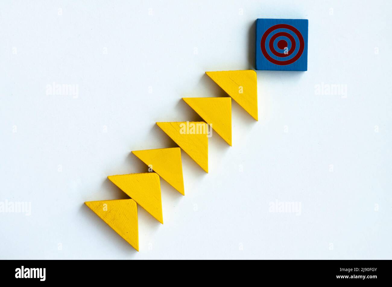 Triangles shape and target symbols on wooden blocks. Goal setting in ...