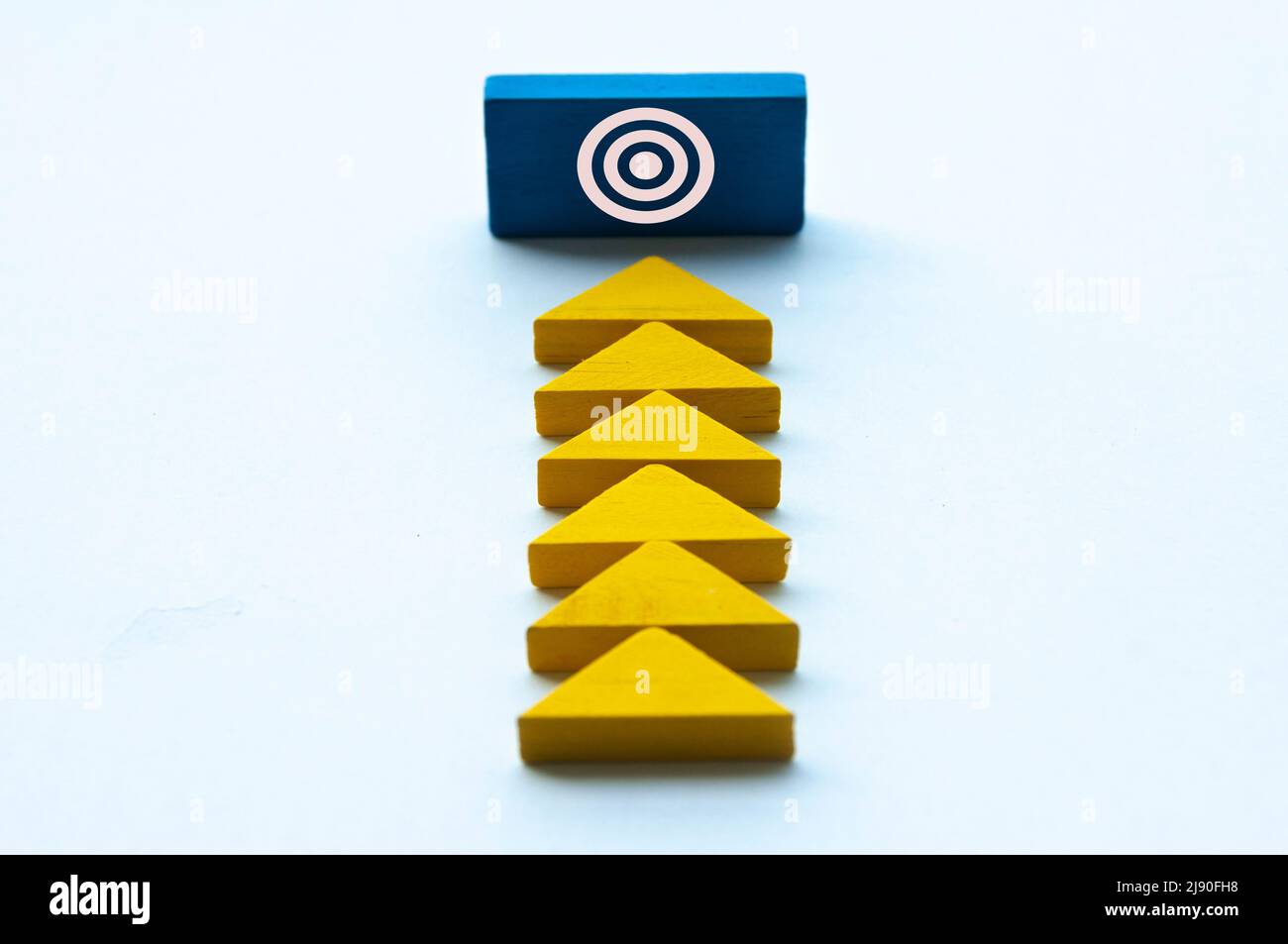 Triangles shape and target symbols on wooden blocks. Goal setting in ...