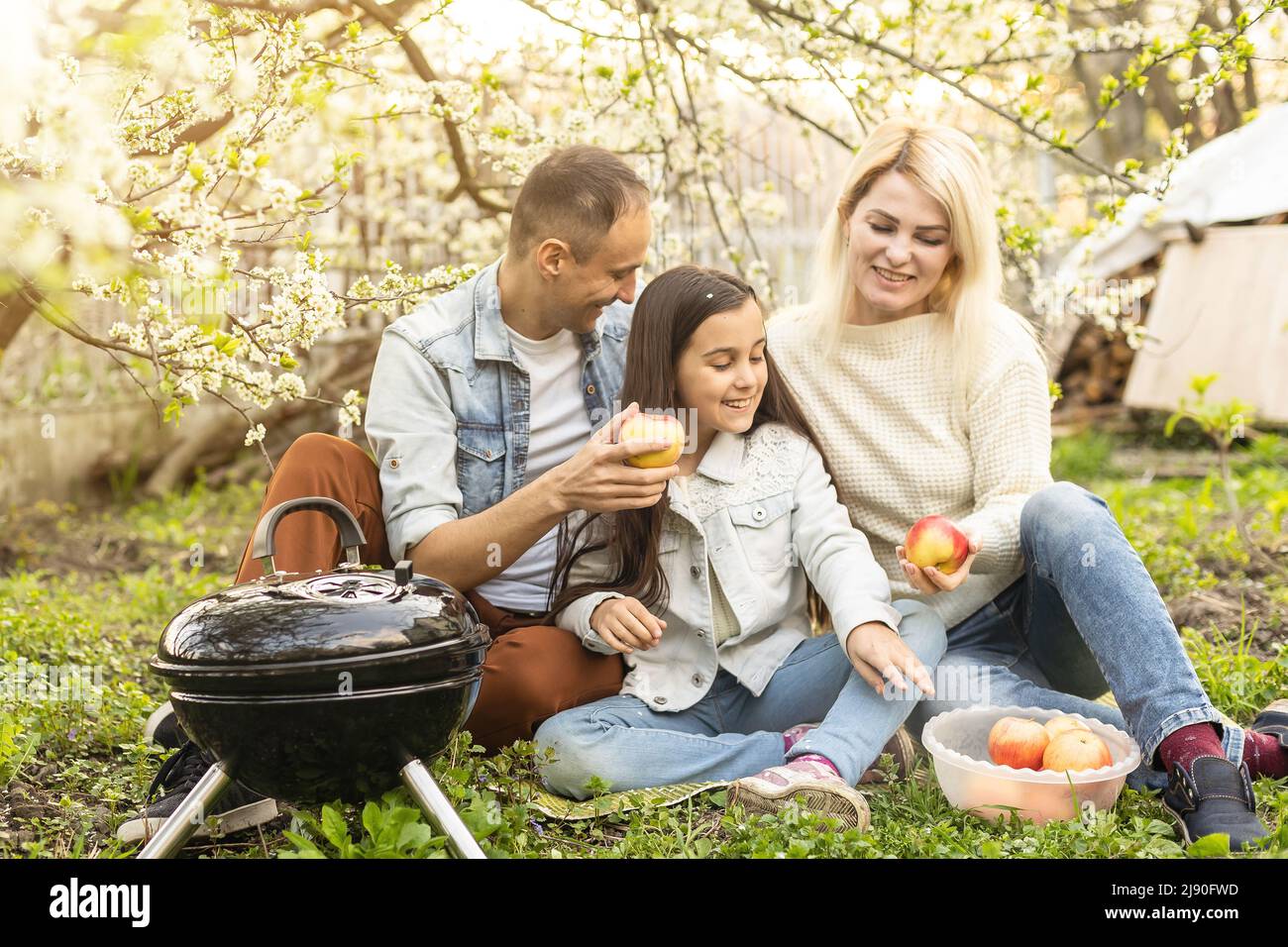 Happy family having a barbecue in their garden in spring. Leisure, food ...