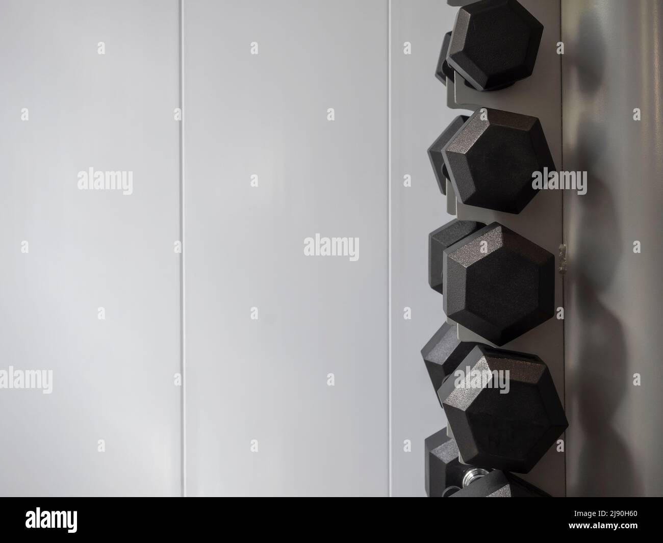 Weights arranged in a gymnasium. Material to exercise the muscles. Gym ...