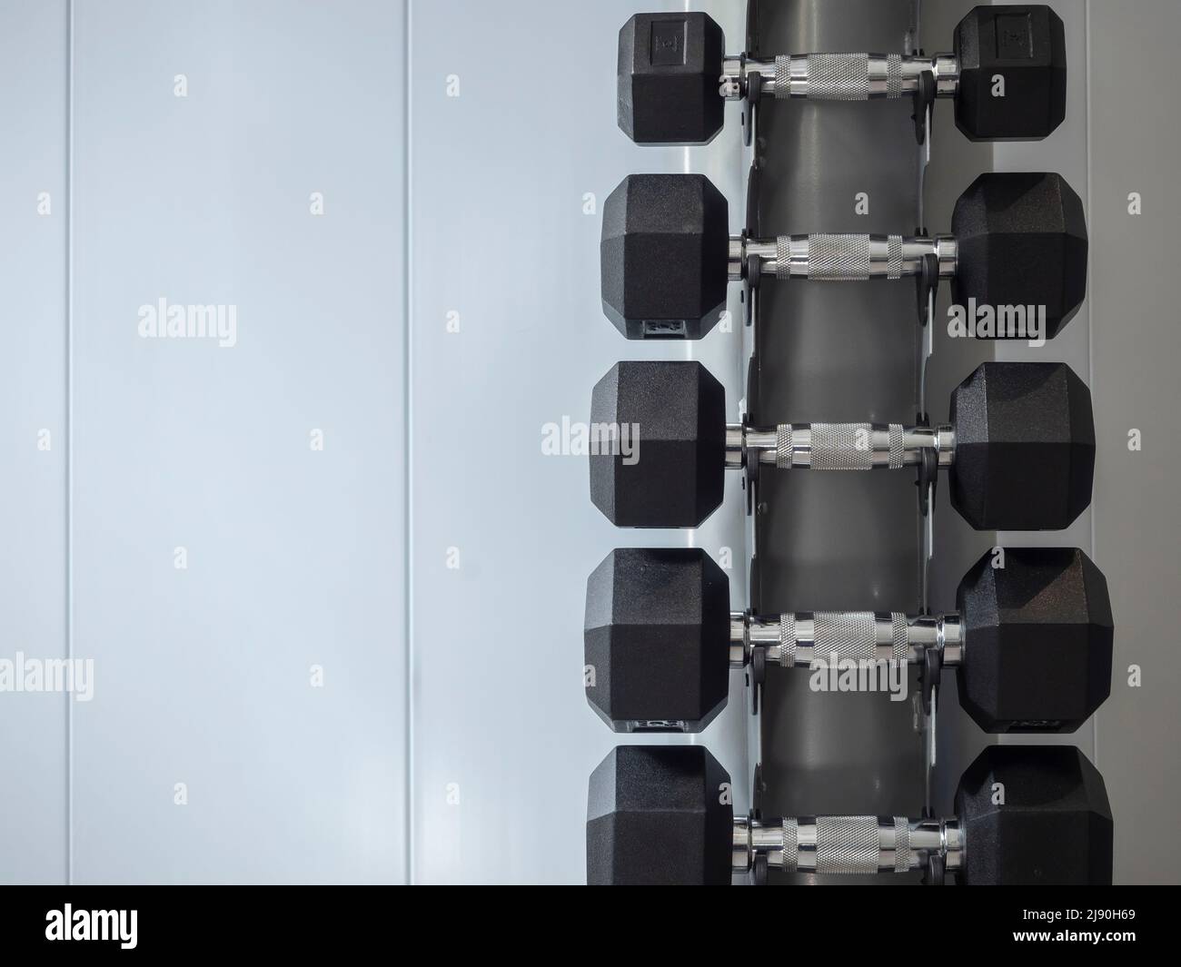 Weights arranged in a gymnasium. Material to exercise the muscles. Gym ...