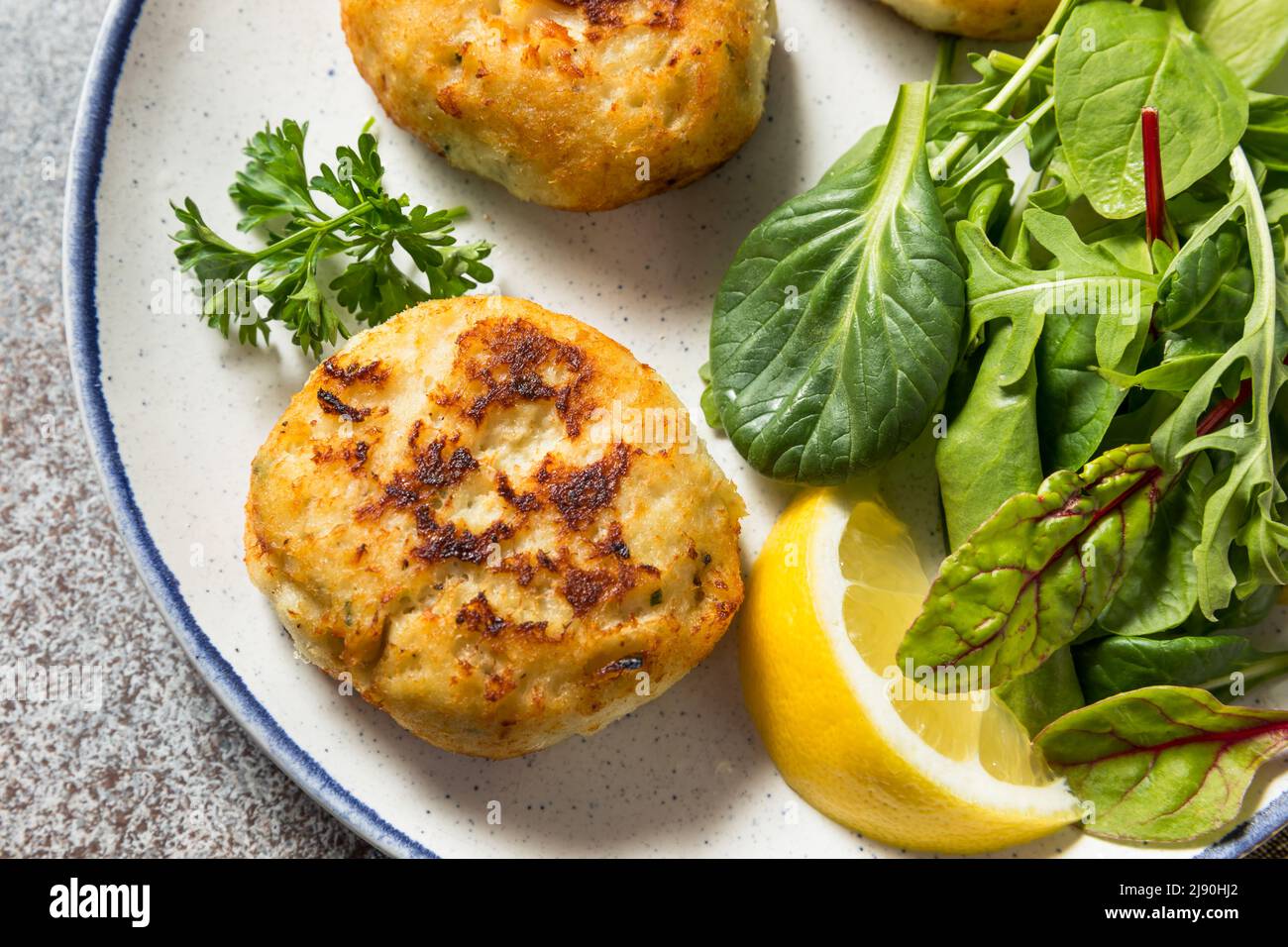Homemade Fried Crab Cakes with Salad and Tartar Sauce Stock Photo - Alamy
