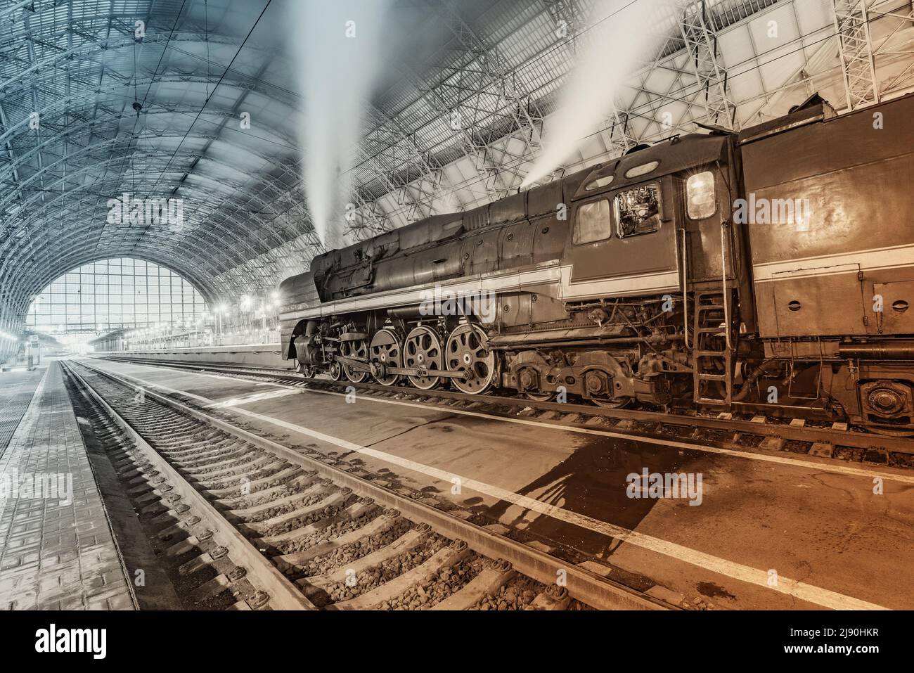 Retro steam train stands by the railway station Stock Photo - Alamy