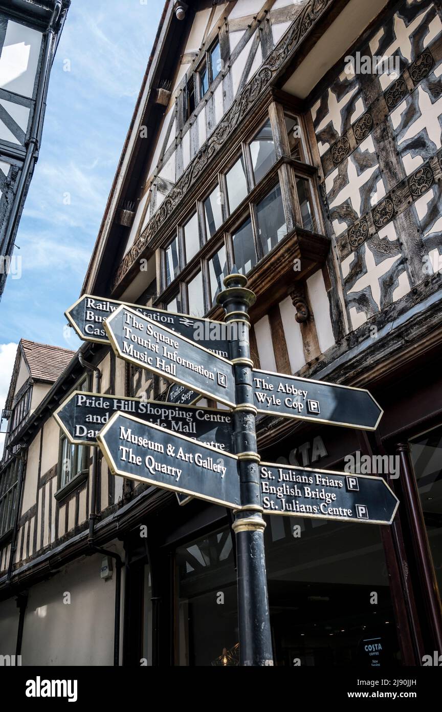 The image is of finger post street signs in the historic city of ...