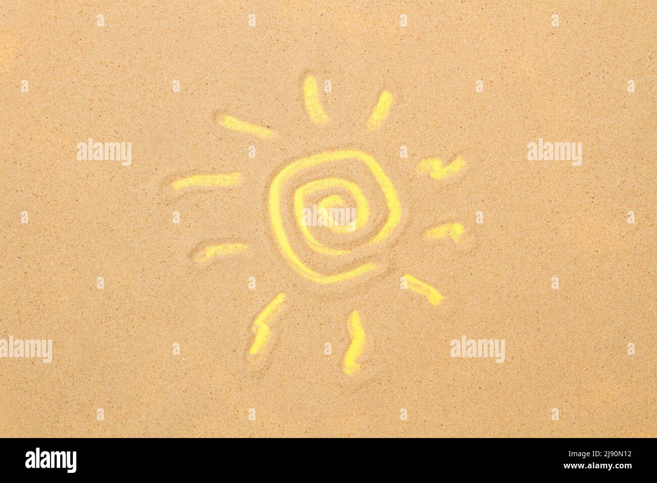 Sun draw on the sand and on a yellowbackground Stock Photo - Alamy