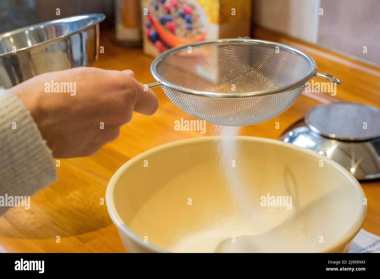 Sugar into the bowl Stock Photo - Alamy