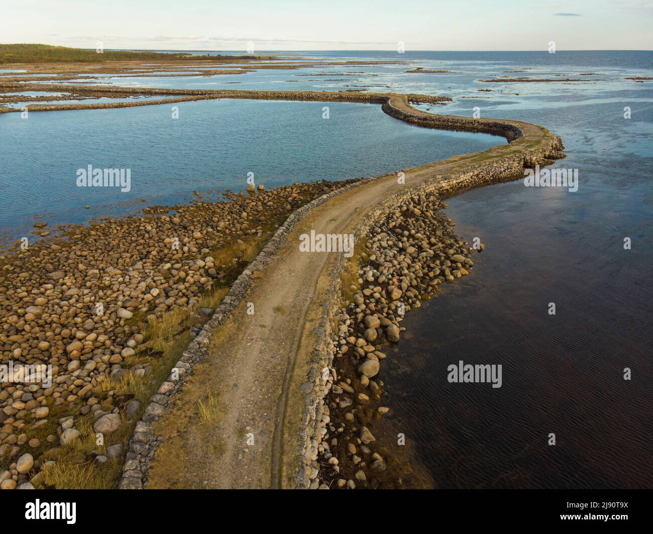 Stone dam-road on Solovki. Road through the White Sea. Big Muksalma ...