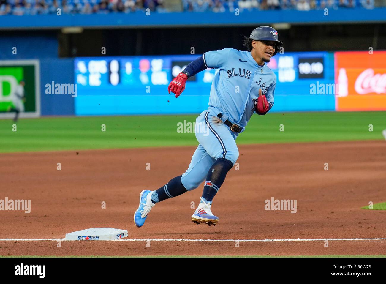 Toronto Blue Jay infielder Santiago Espinal (5) rounds third base during an MLB game between ...