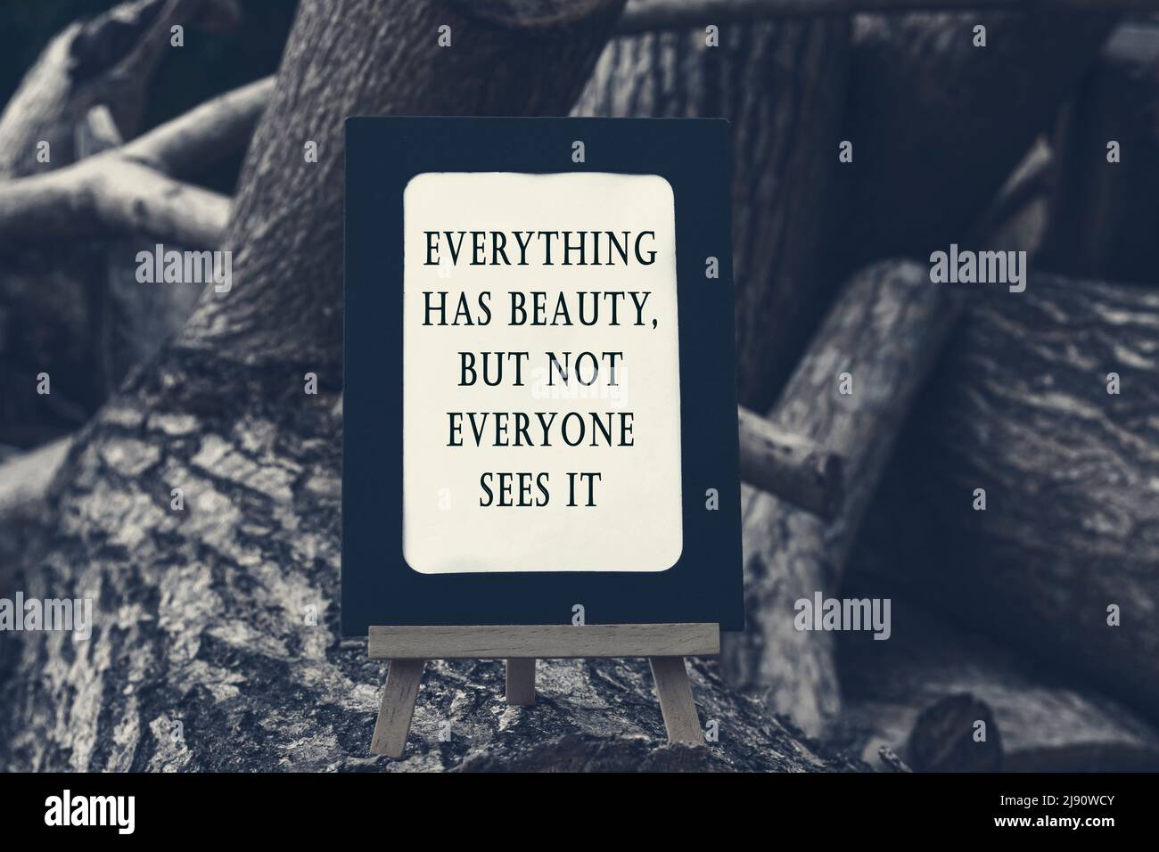 Motivational quote on a chalkboard isolated on tree trunk - Everything ...