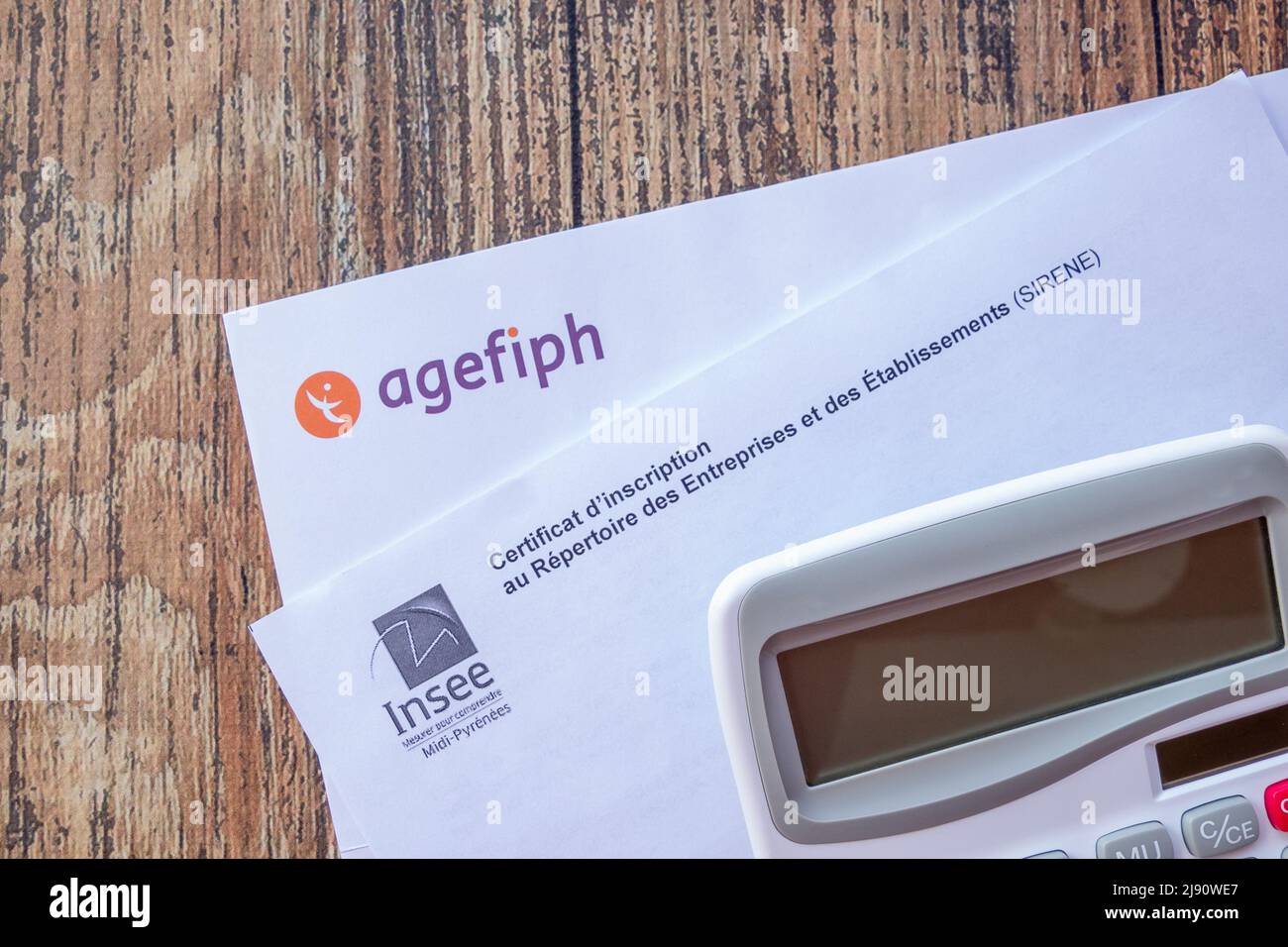 French courier with the agefiph logo and a calculator Stock Photo - Alamy
