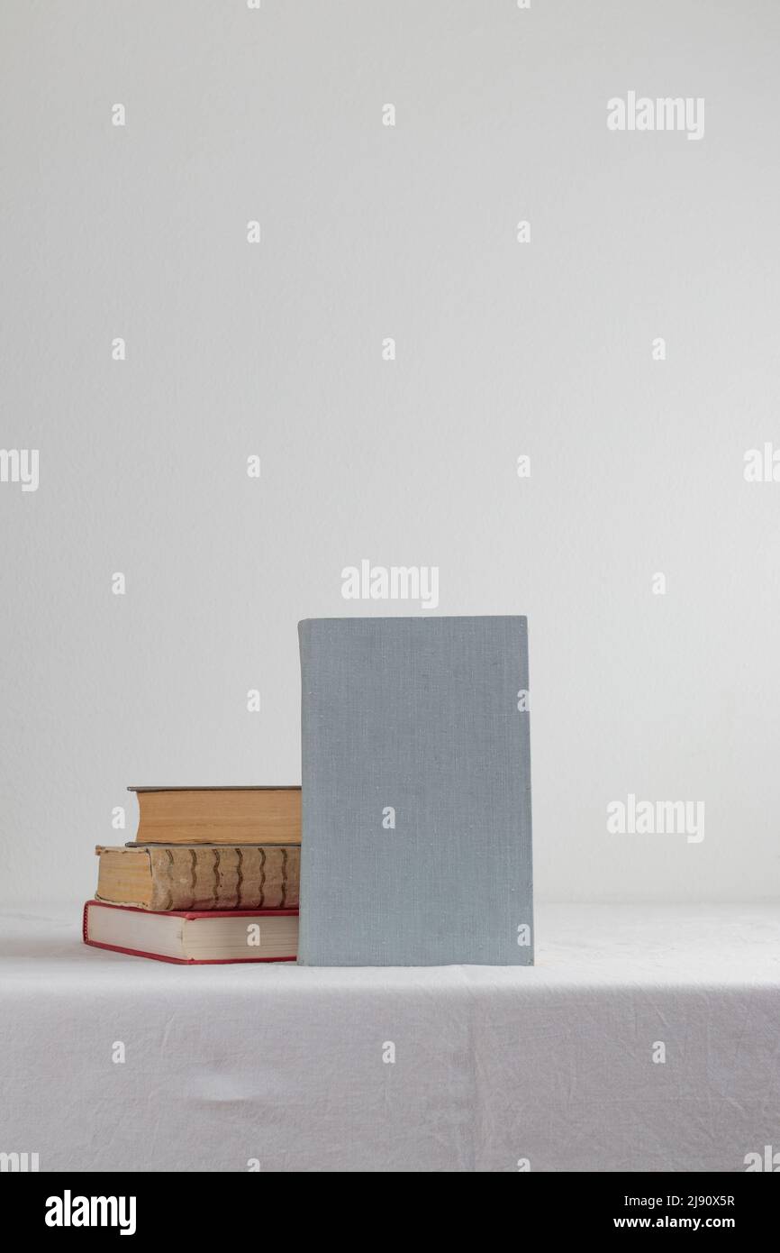 Stack of old rustic vintage books on white table Stock Photo - Alamy