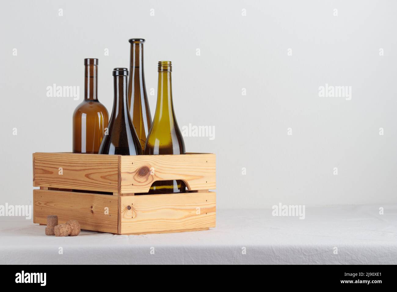 Green wine bottles in the box on the white table Stock Photo - Alamy