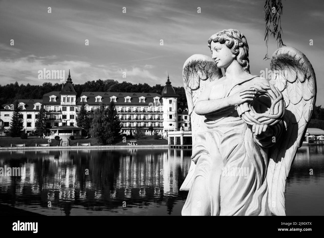 House and stone statue in a forest on a lake Stock Photo - Alamy