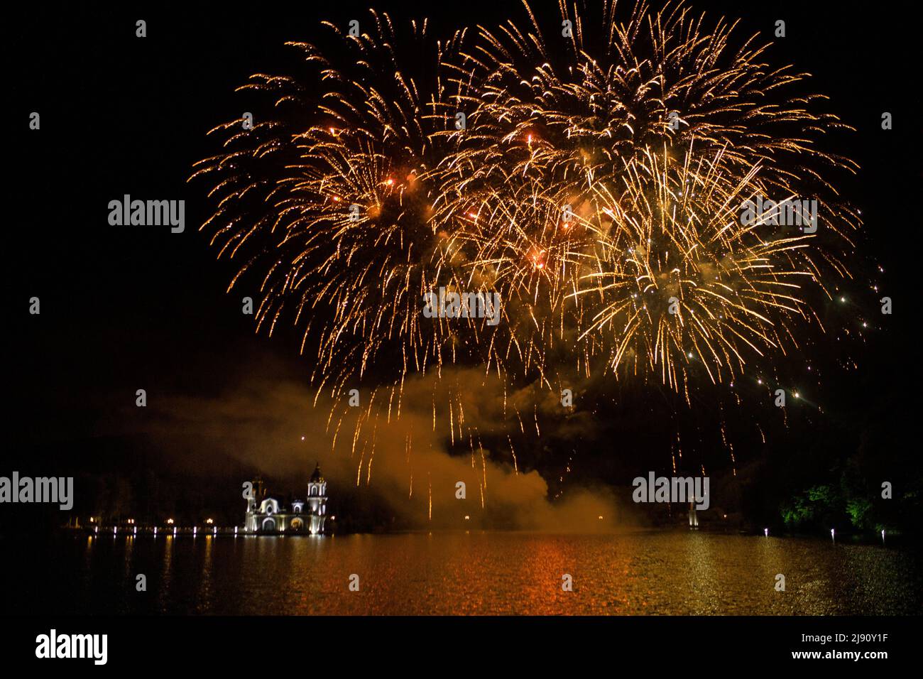 Colorful festive fireworks over the lake house Stock Photo - Alamy