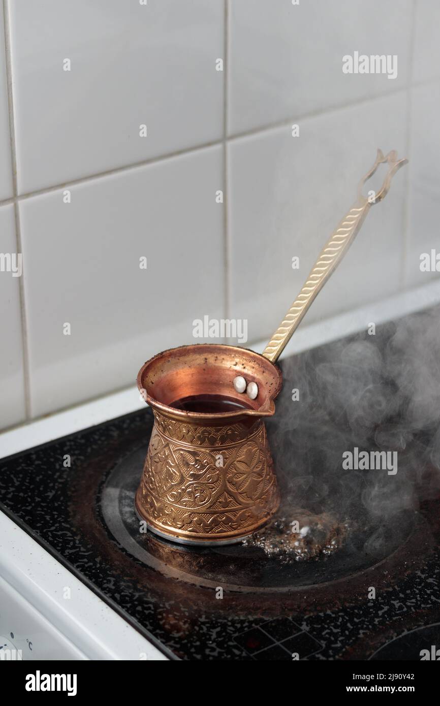 Runaway turkish coffeein a cezve on a stove Stock Photo - Alamy