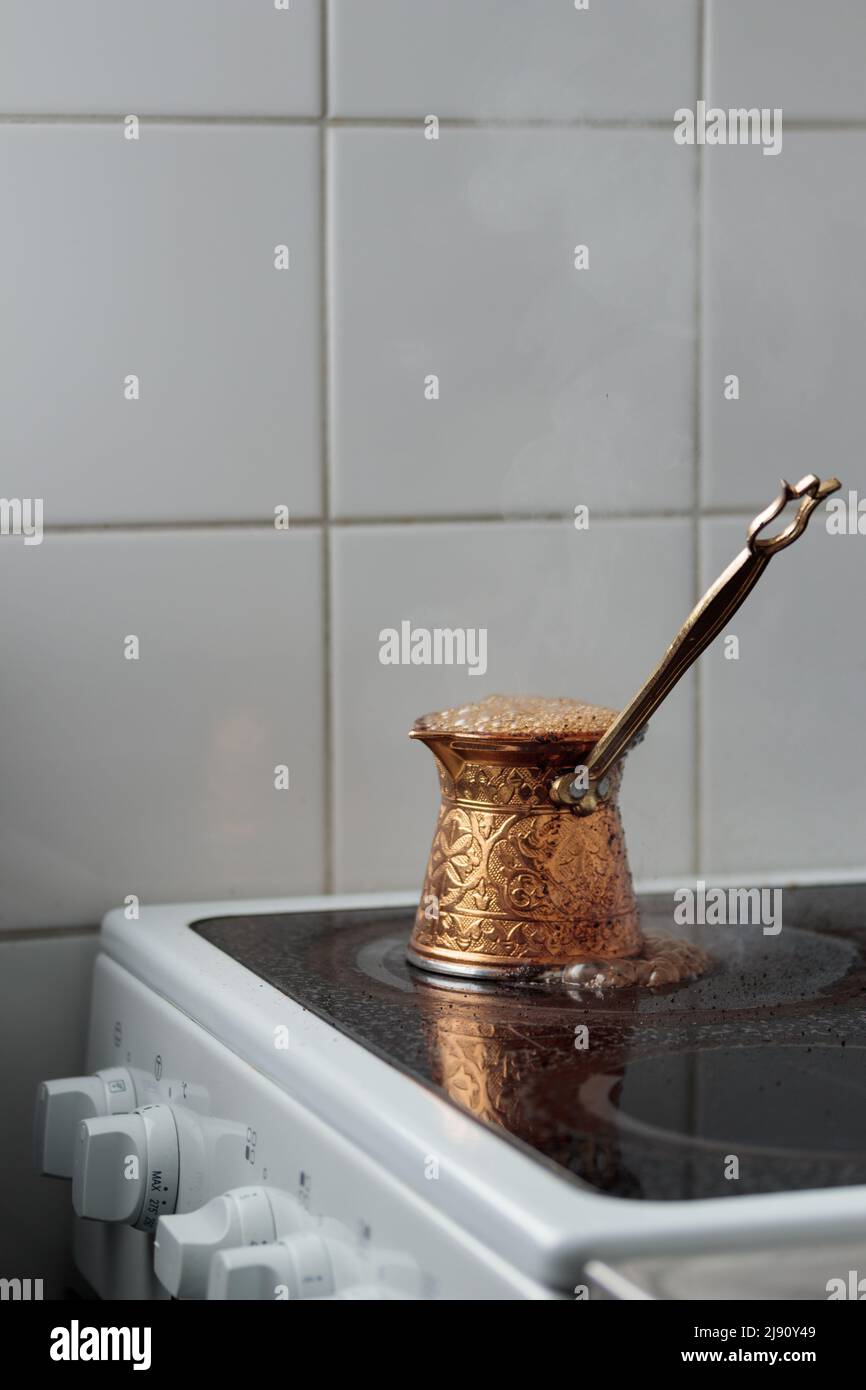 Runaway turkish coffeein a cezve on a stove Stock Photo - Alamy