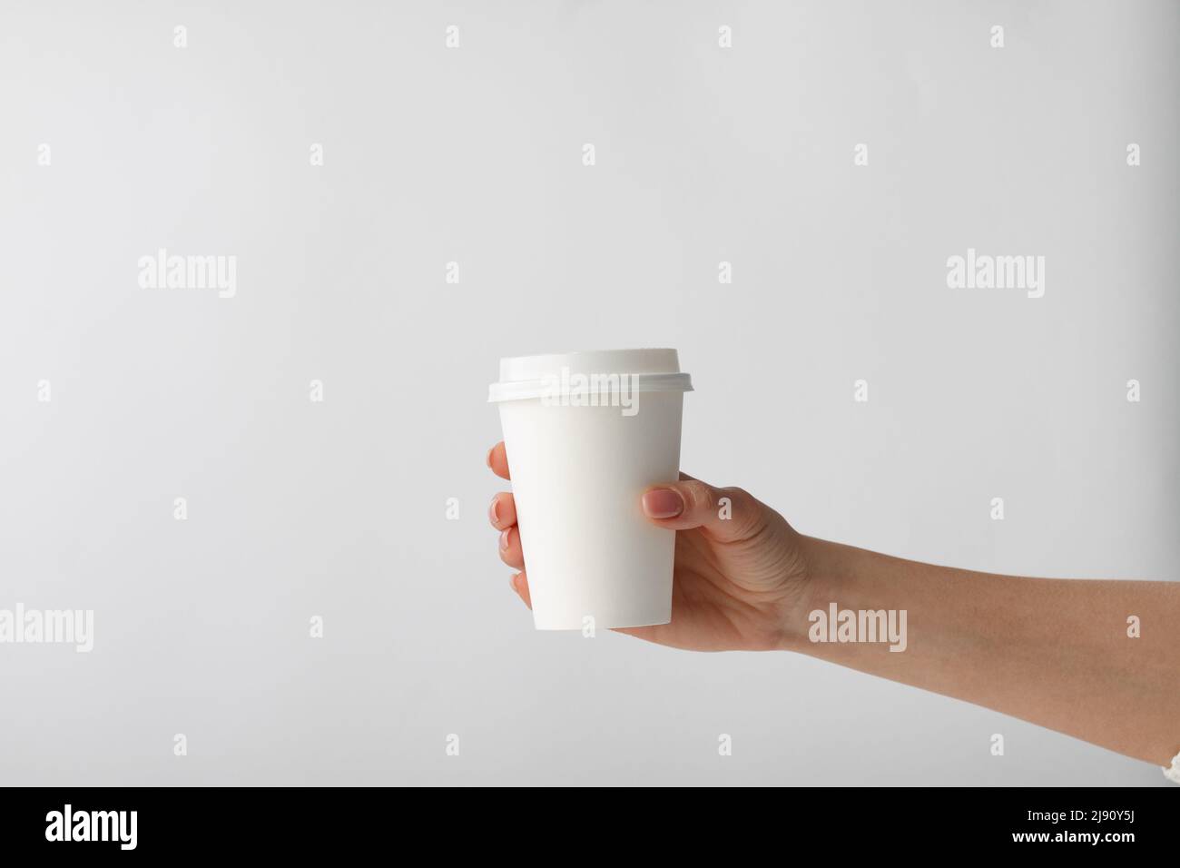 Human hand holding a coffee cup on a white background Stock Photo - Alamy