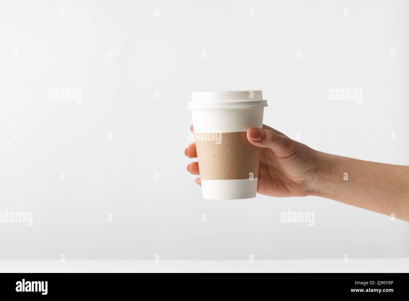 Human hand holding a coffee cup on a white background Stock Photo - Alamy