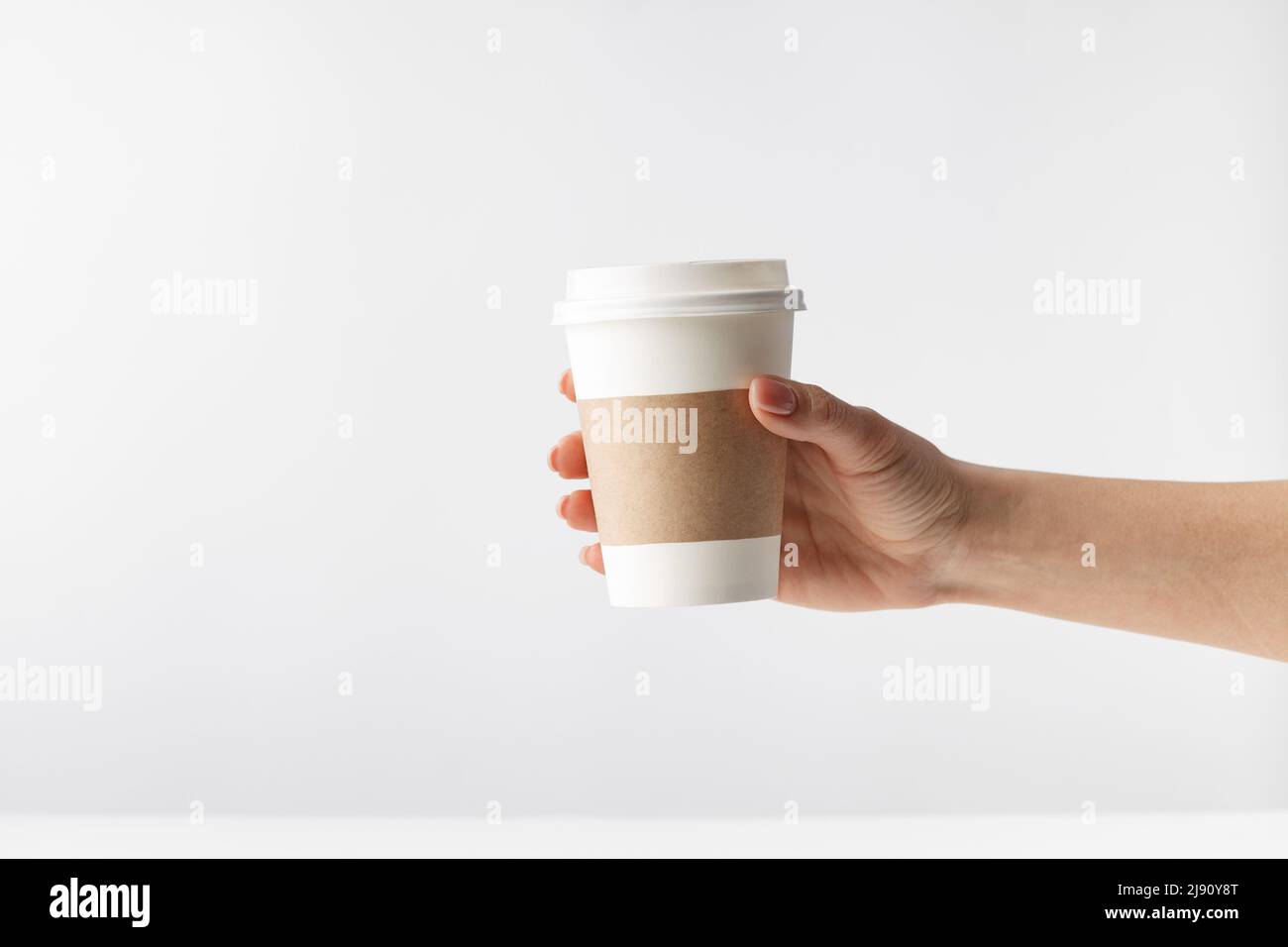 Human hand holding a coffee cup on a white background Stock Photo - Alamy