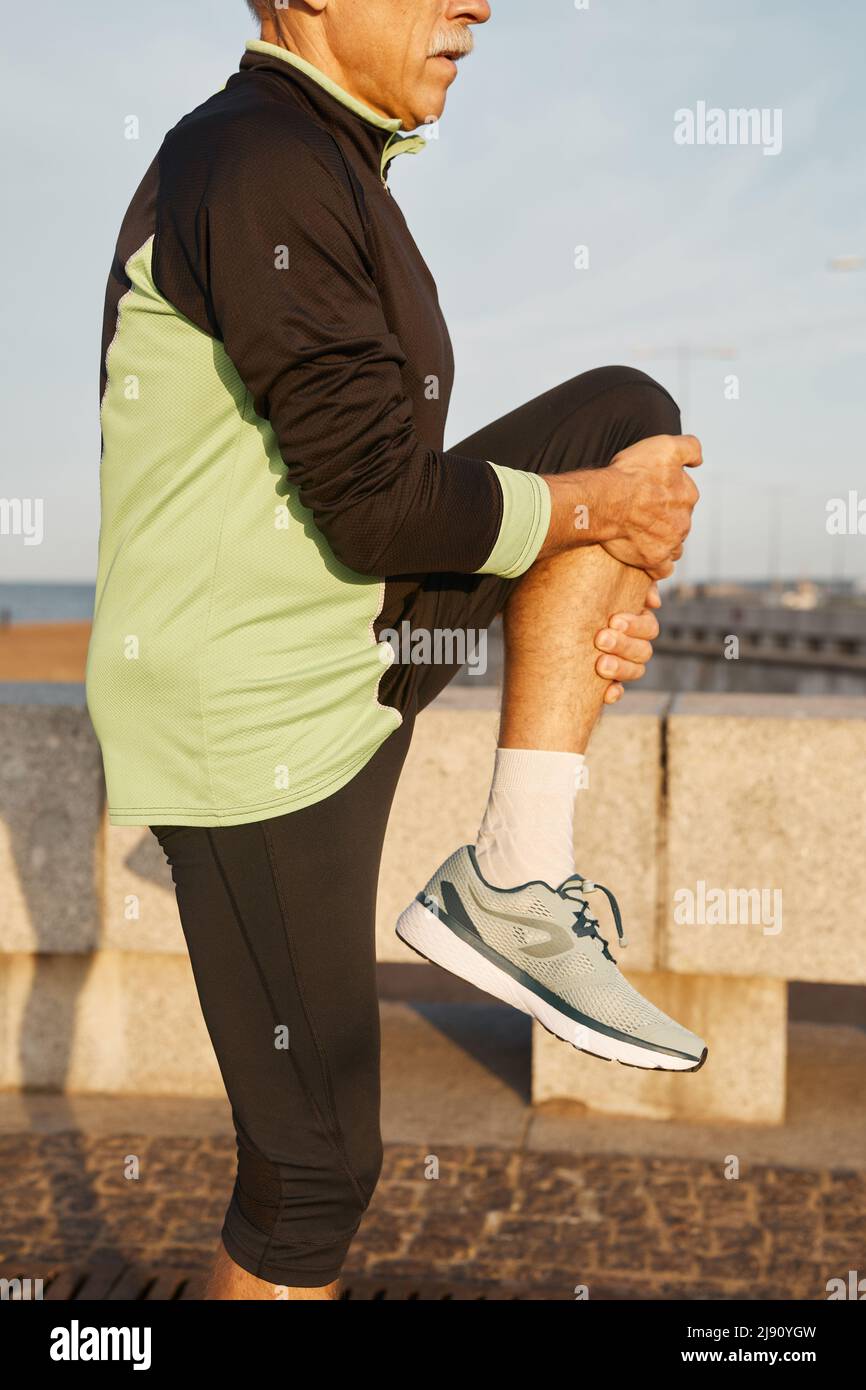 Medium long side view shot of unrecognizable man doing morning exercise ...