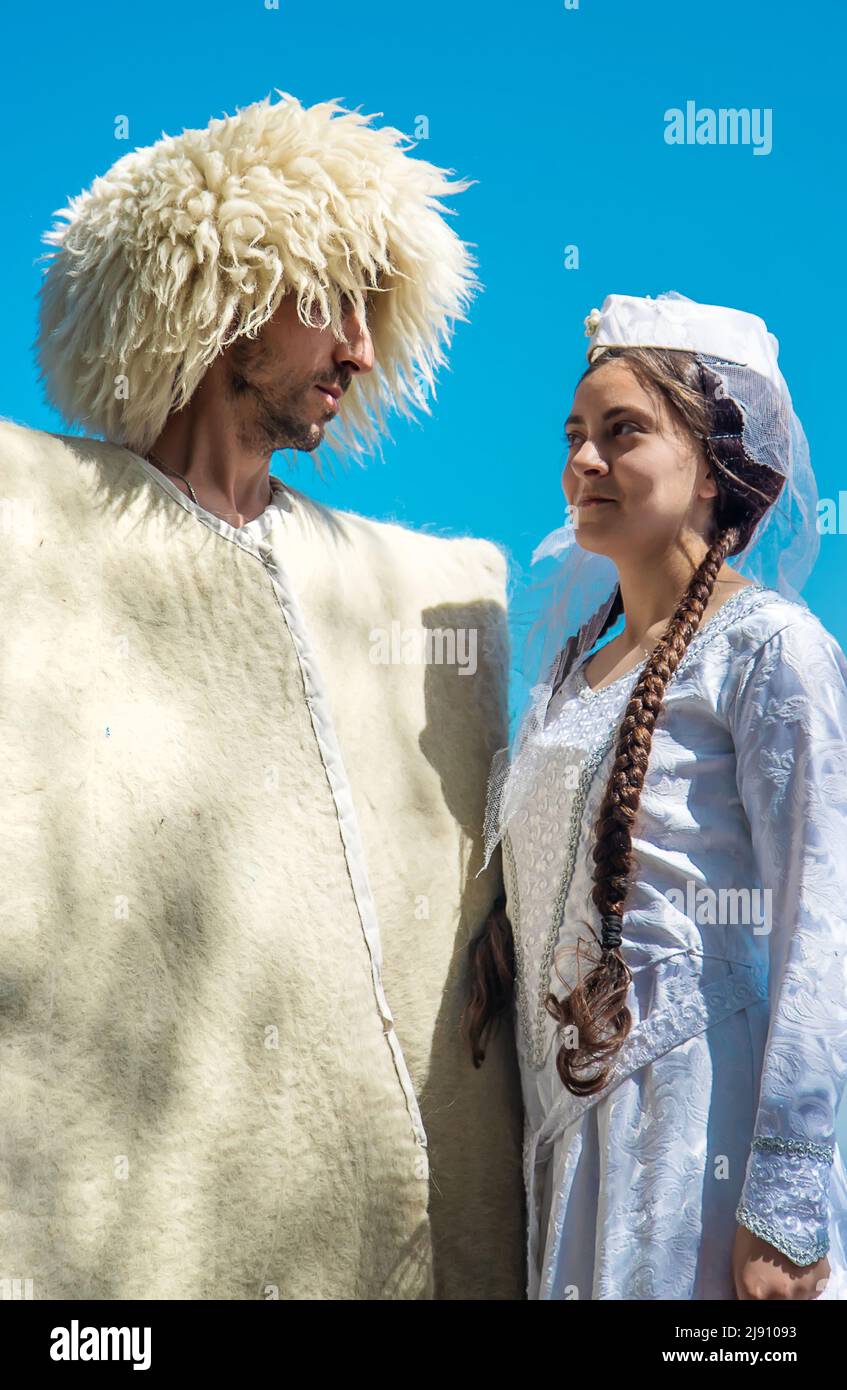 A Georgian man and a woman in a hat. Selective focus Stock Photo - Alamy