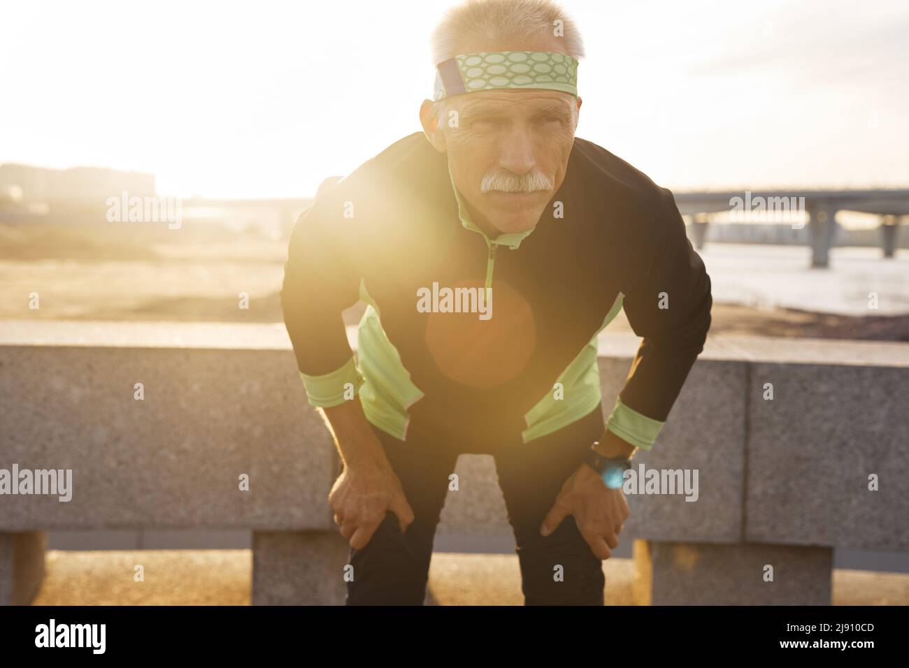 Caucasian man with moustache in sportswear bending forward horizontal ...